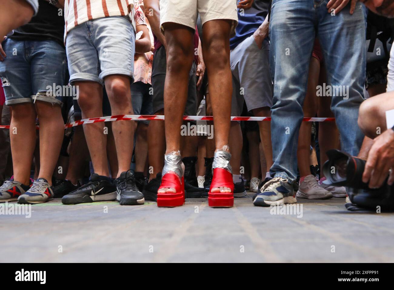 A group of men display the heels as they participate in the heel race ...