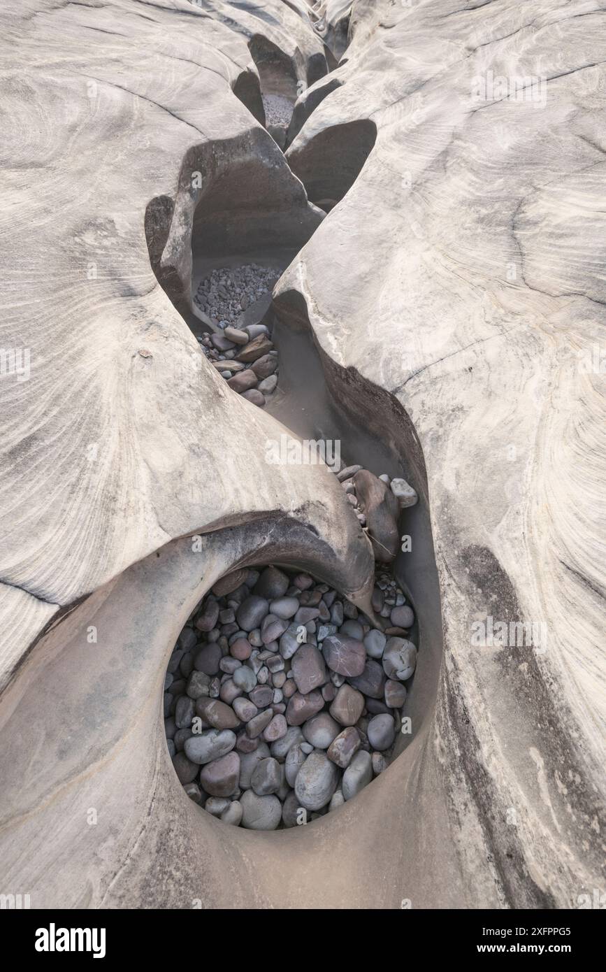 Grinding stones and pebbles crack of the river bed fprmed by swirling ...