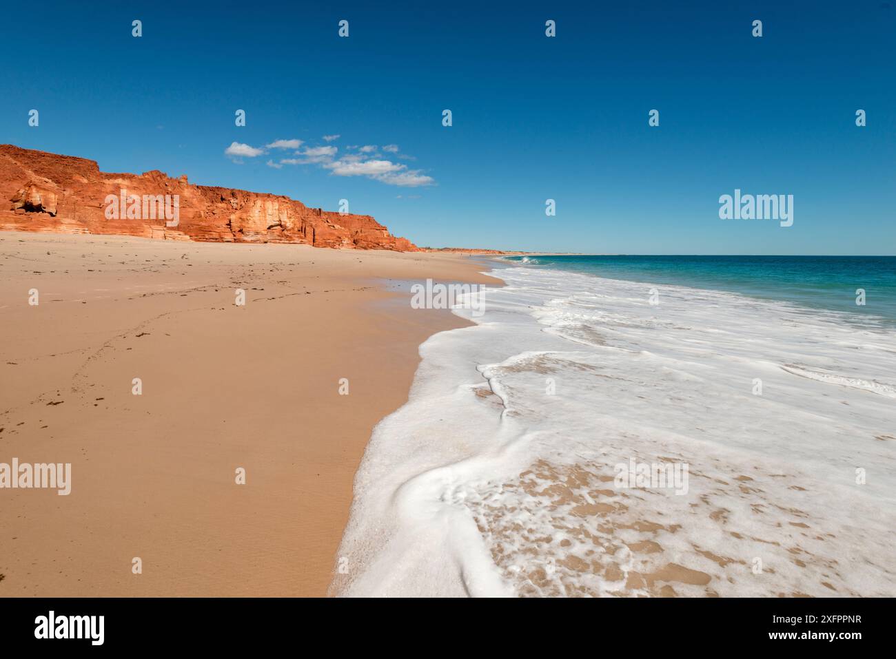 Beach waves on the white sands. Spectacular views of ochre-coloured ...