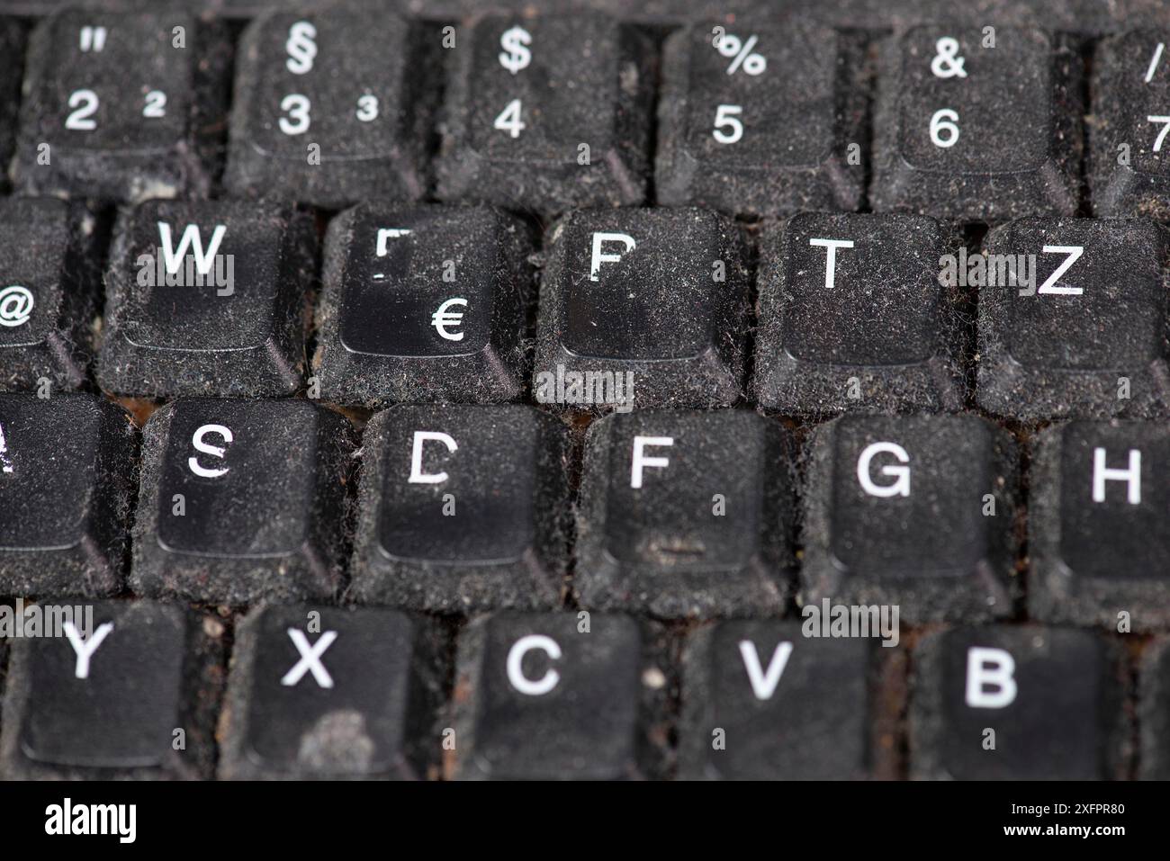 Filthy and dusty computer keyboard on an office desk, dirty electronic ...