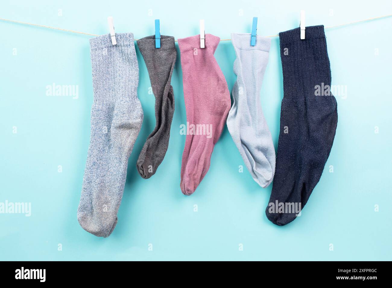 Lost socks hanging on a clothes line with clothespin, missing sock ...