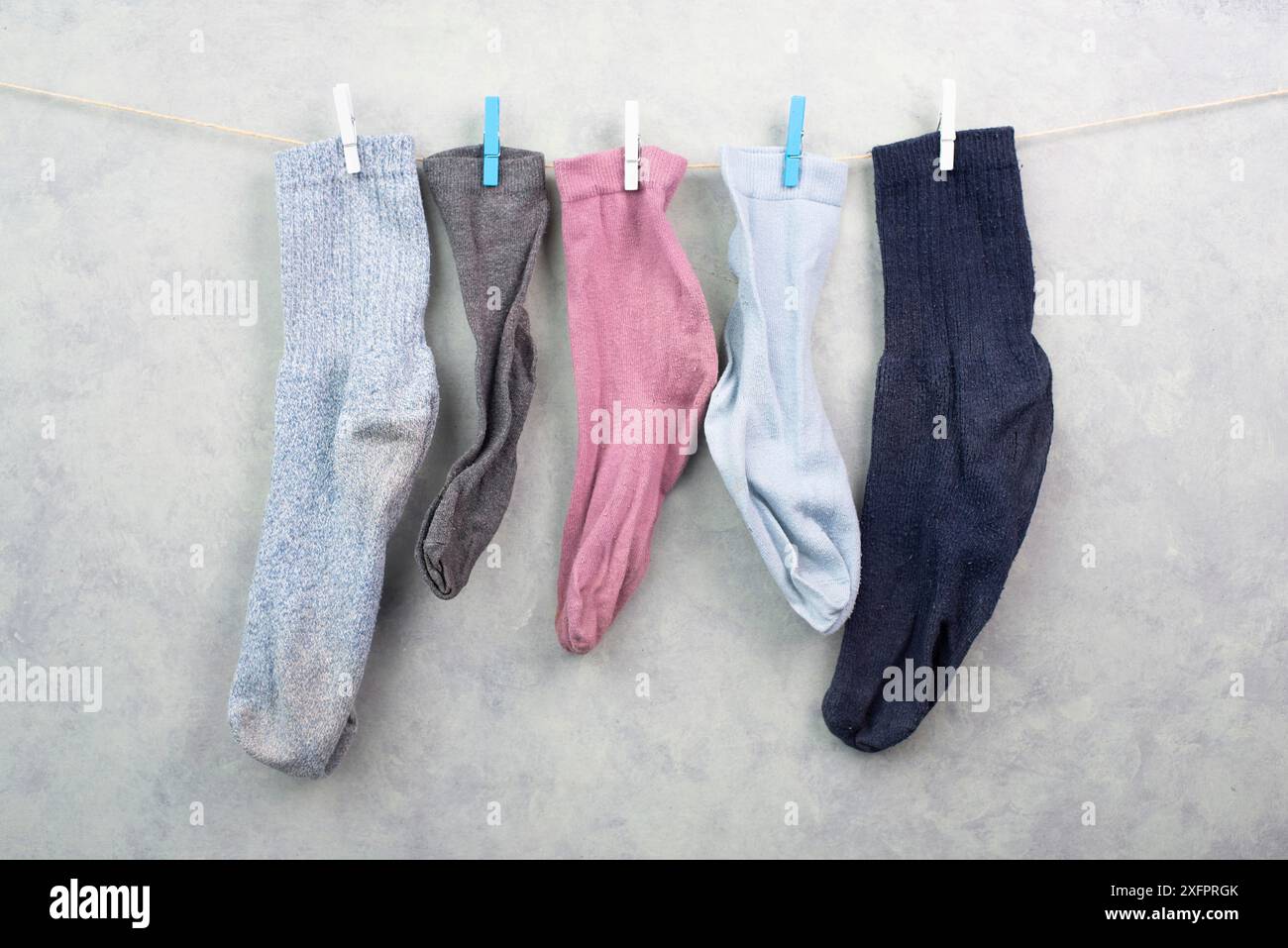 Lost socks hanging on a clothes line with clothespin, missing sock ...