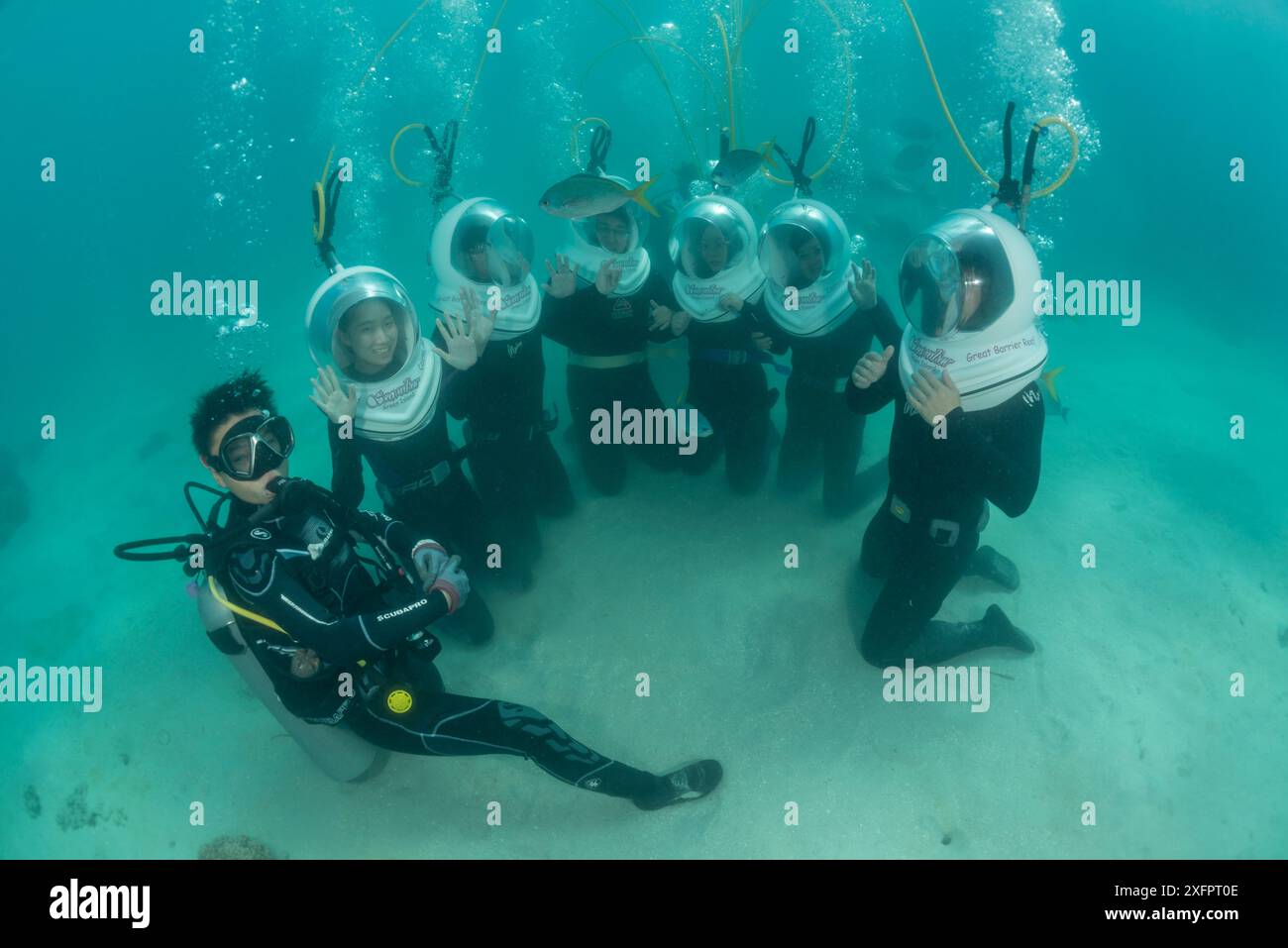 Tourists helmet diving and walking around the shallow reefs of Green ...