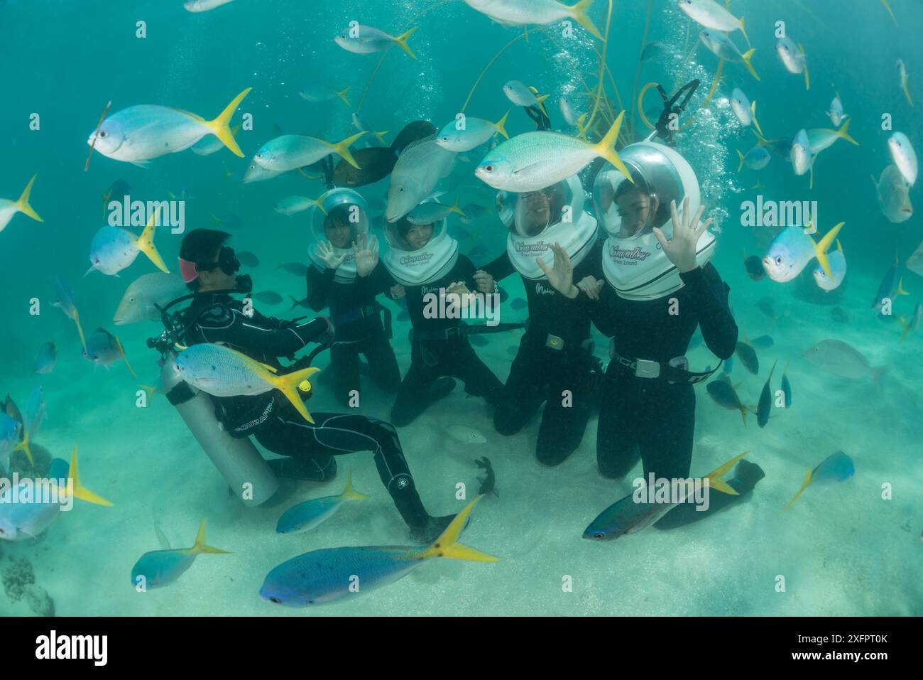 Tourists helmet diving and walking around the shallow reefs of Green ...