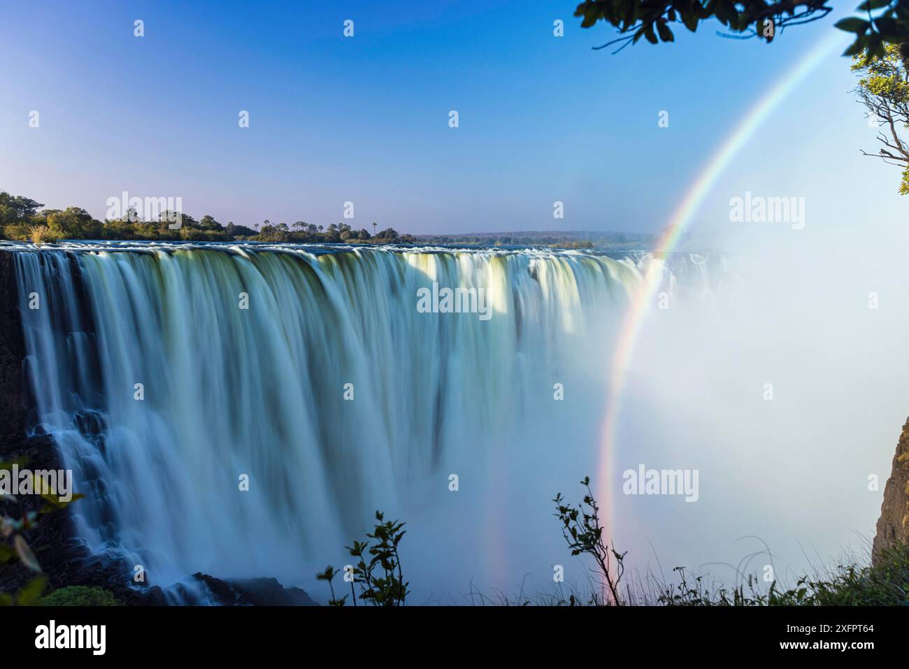 Scenic view of rainbow arching the Zambezi river waterfall of Victoria ...