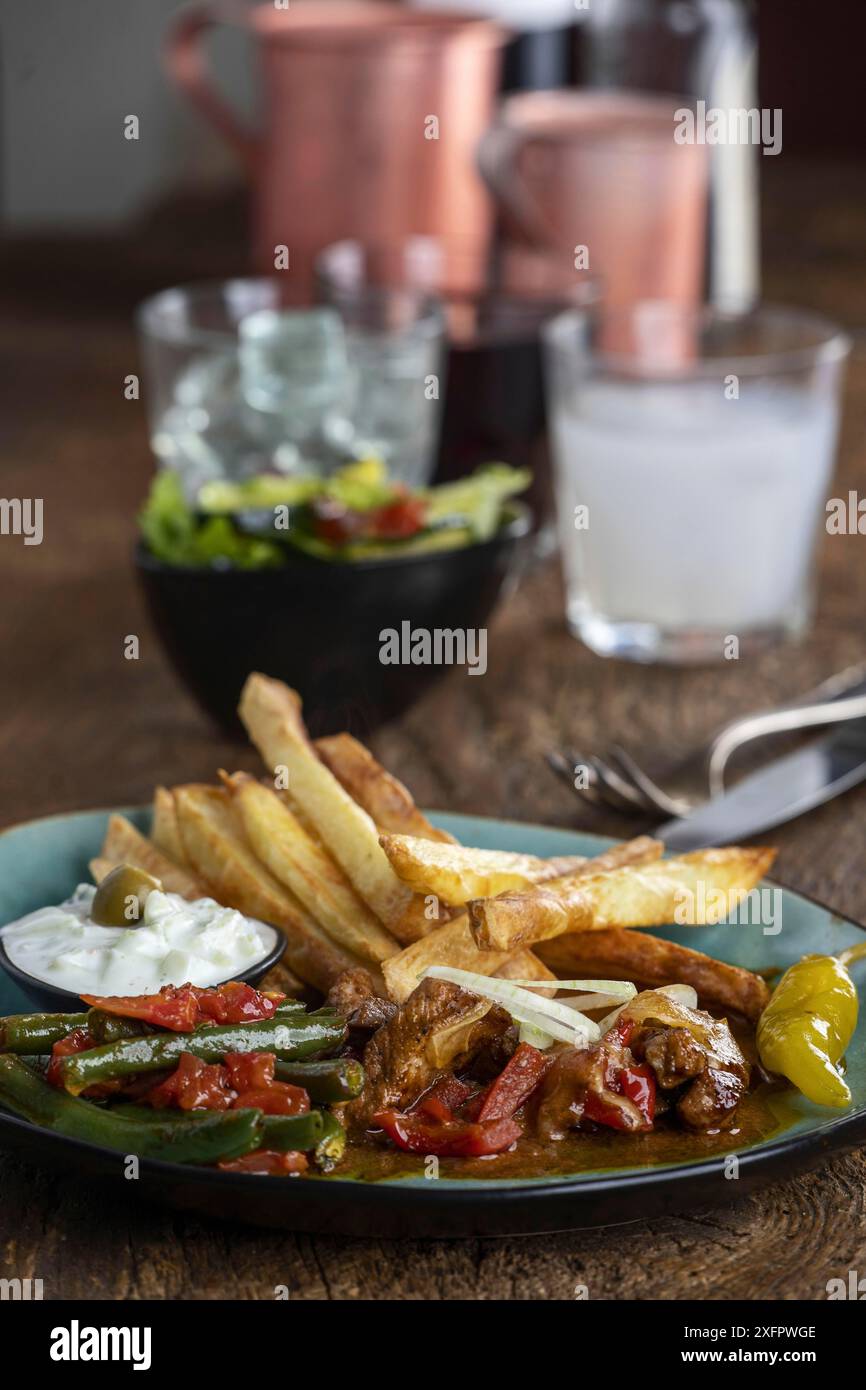 Greek gyros with metaxa sauce and chips Stock Photo - Alamy