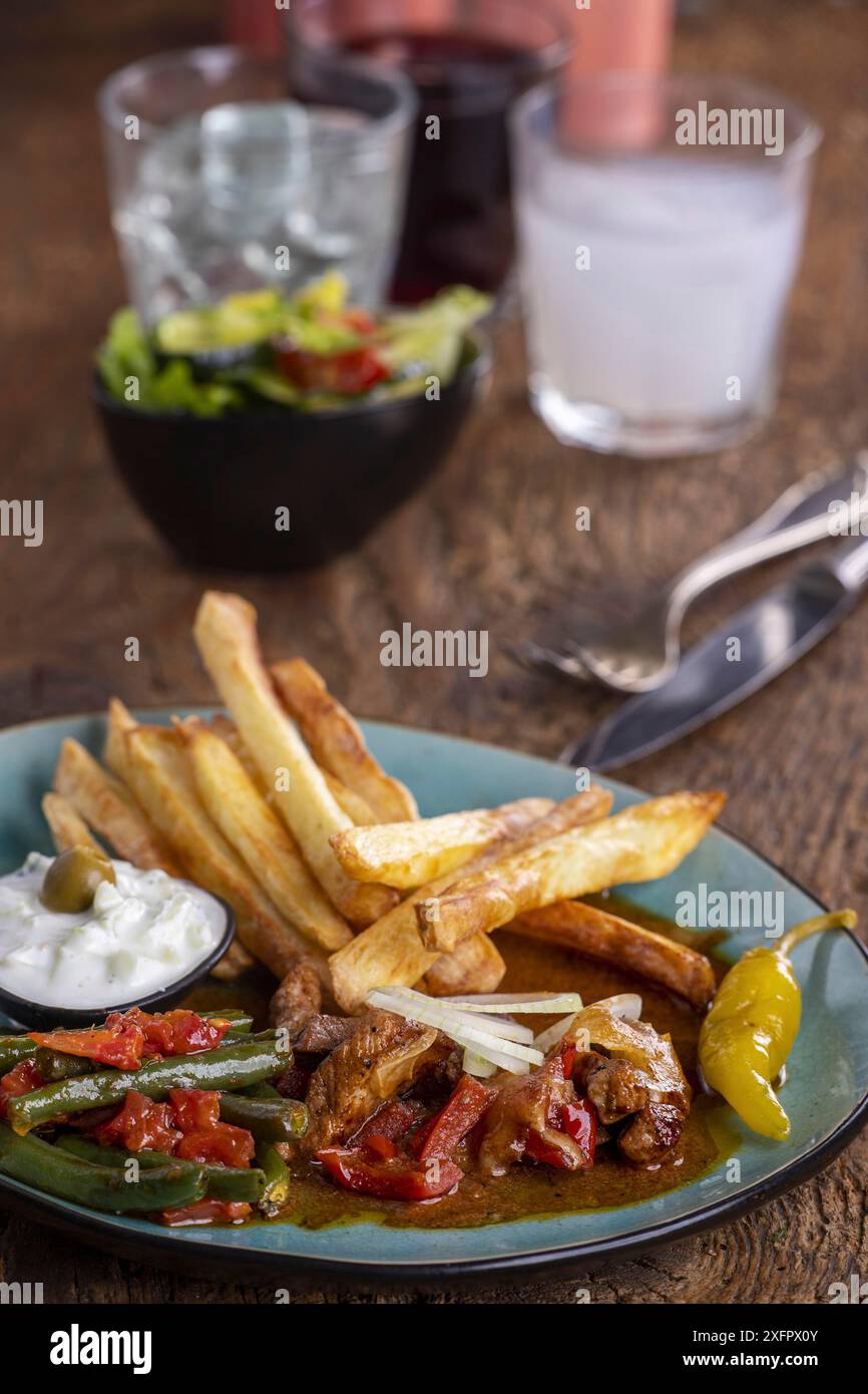 Greek gyros with metaxa sauce and chips Stock Photo - Alamy
