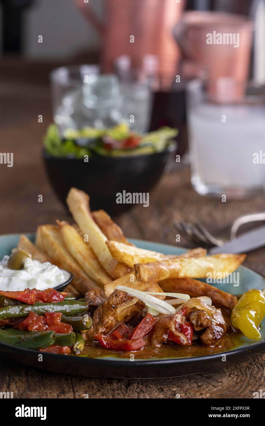 Greek gyros with metaxa sauce and chips Stock Photo - Alamy