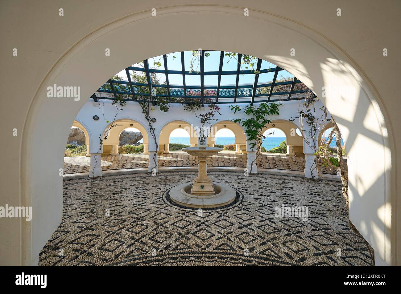 Well-structured courtyard with ornamental paving and glass roof ...