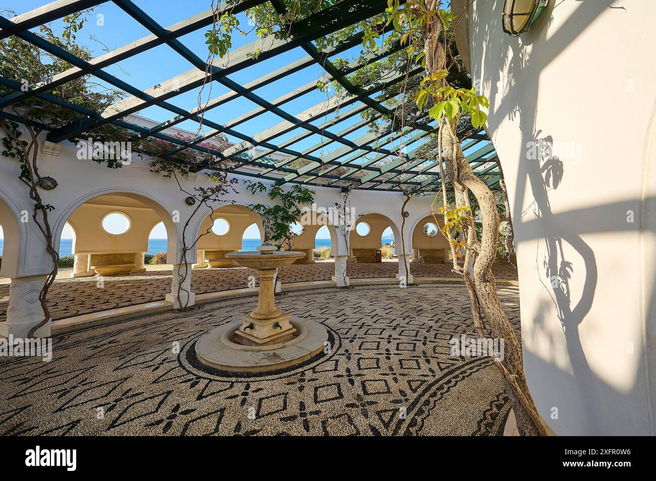 Inner courtyard of a circular building with glass roof, plants and ...