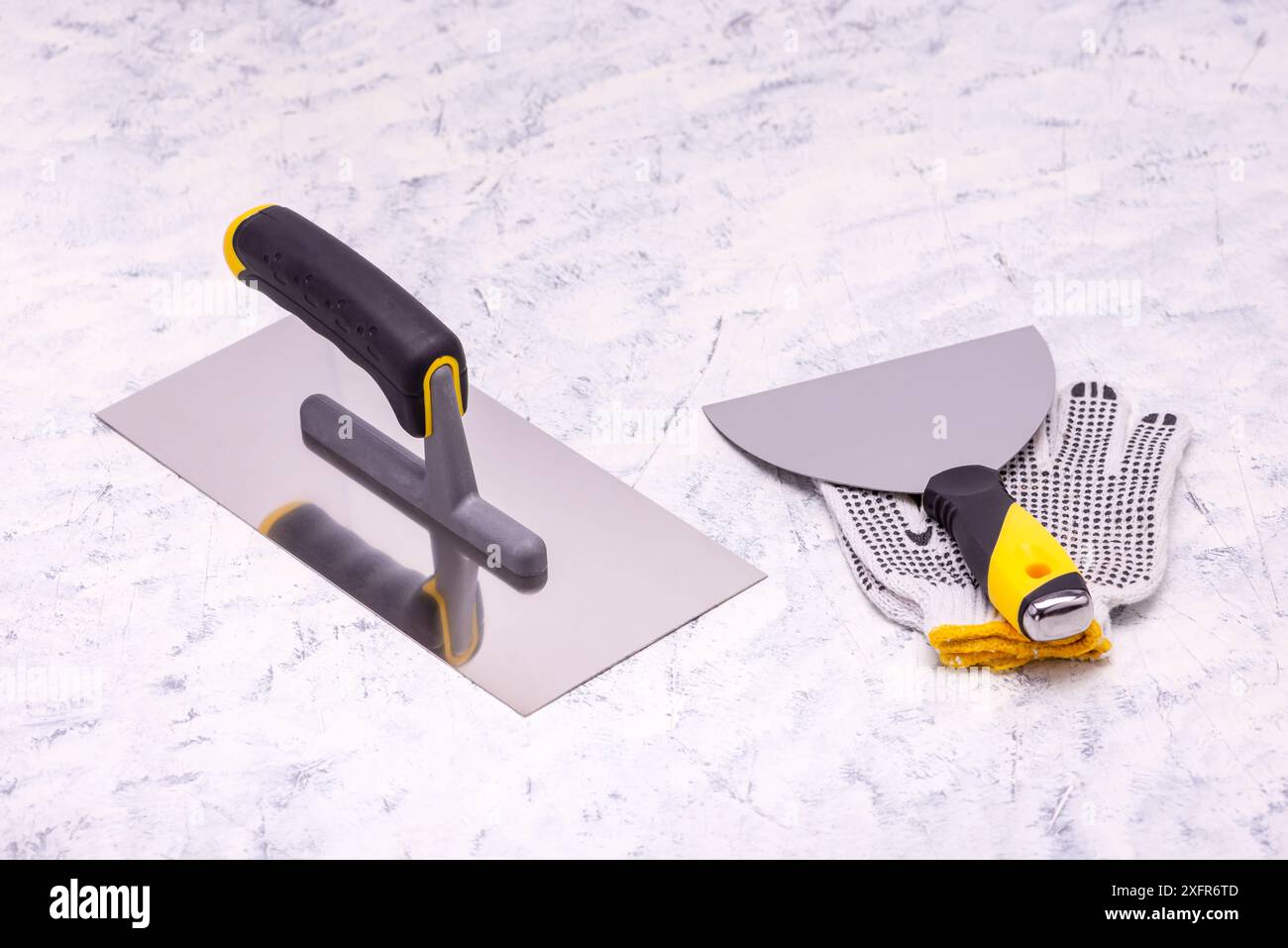 A set of hand tools for plastering and leveling the walls on white-grey ...