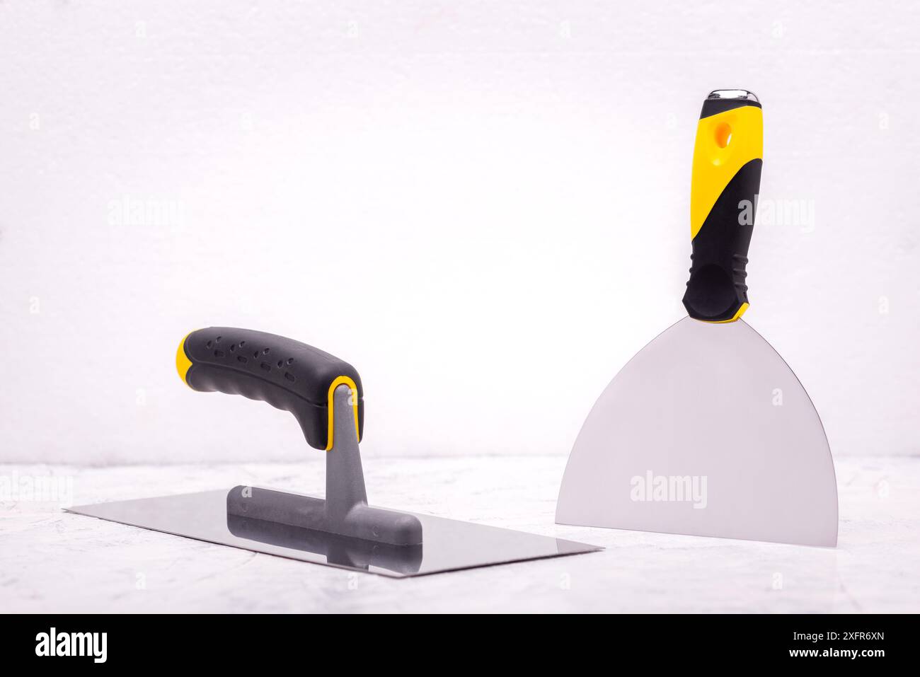 A set of hand tools for plastering and smoothing the walls on white ...