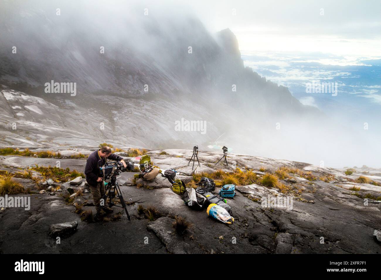 Camera operator Richard Kirby filming on the summit of Mount Kinabalu ...