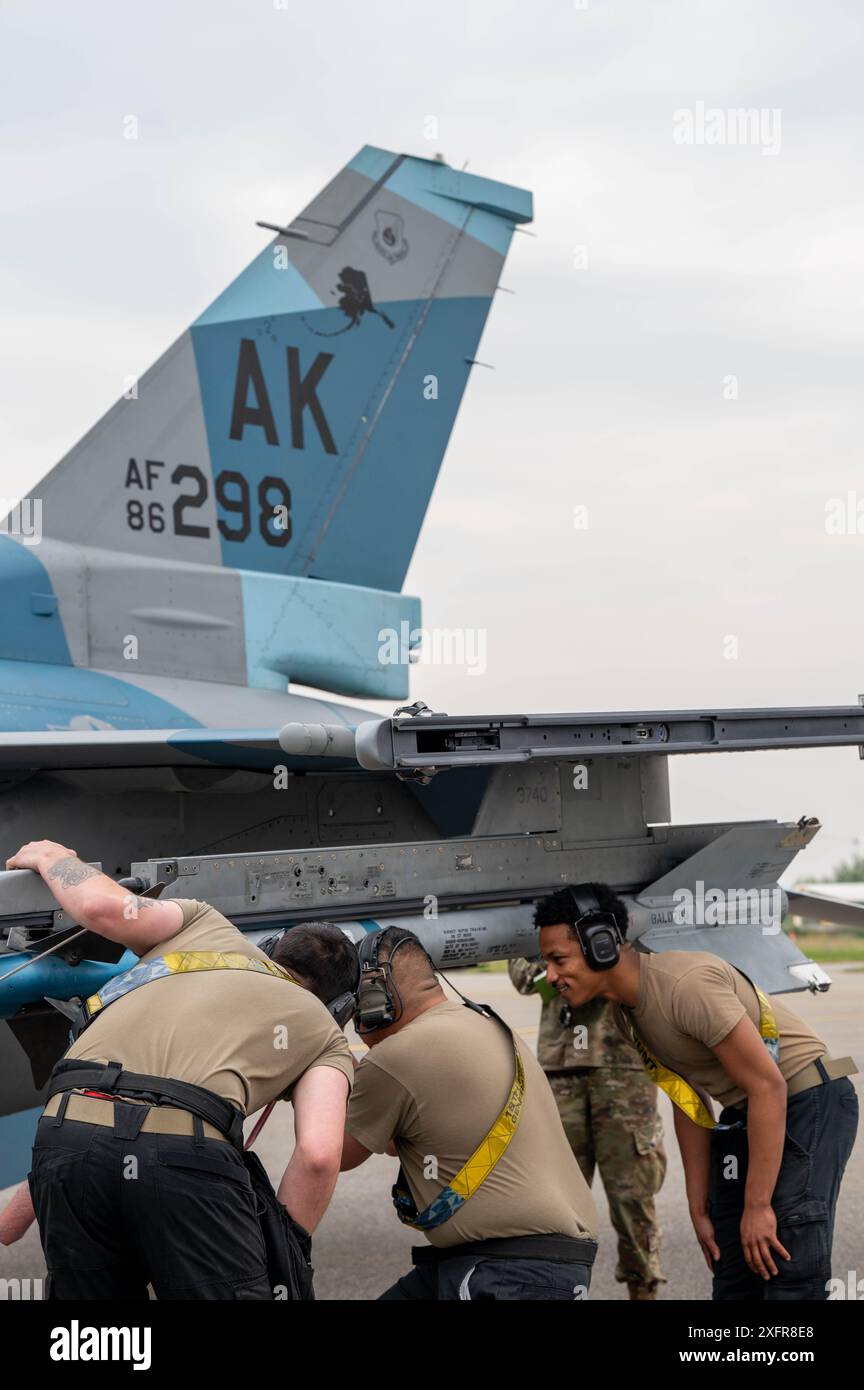 Airmen assigned to the 18th Fighter Generation Squadron inspect a piece ...