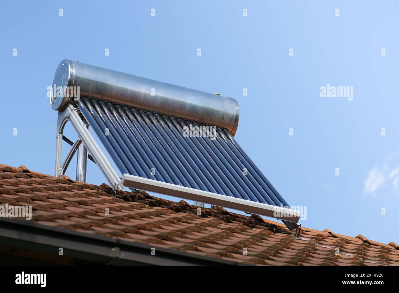 solar water heater on a roof top, solar water heating panel, blue sky ...