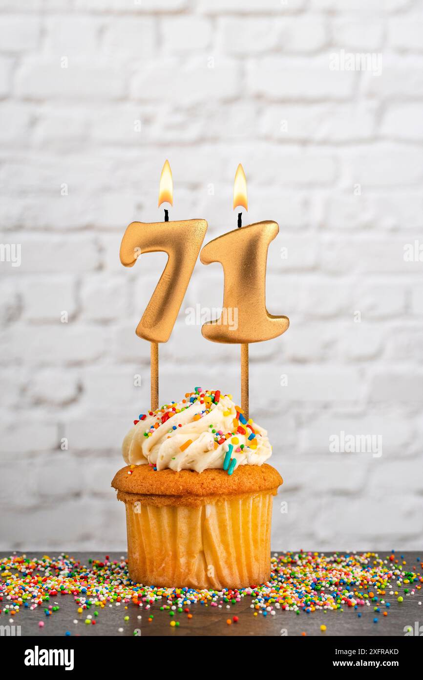 Golden birthday candle number 71 with cupcake - White block wall ...