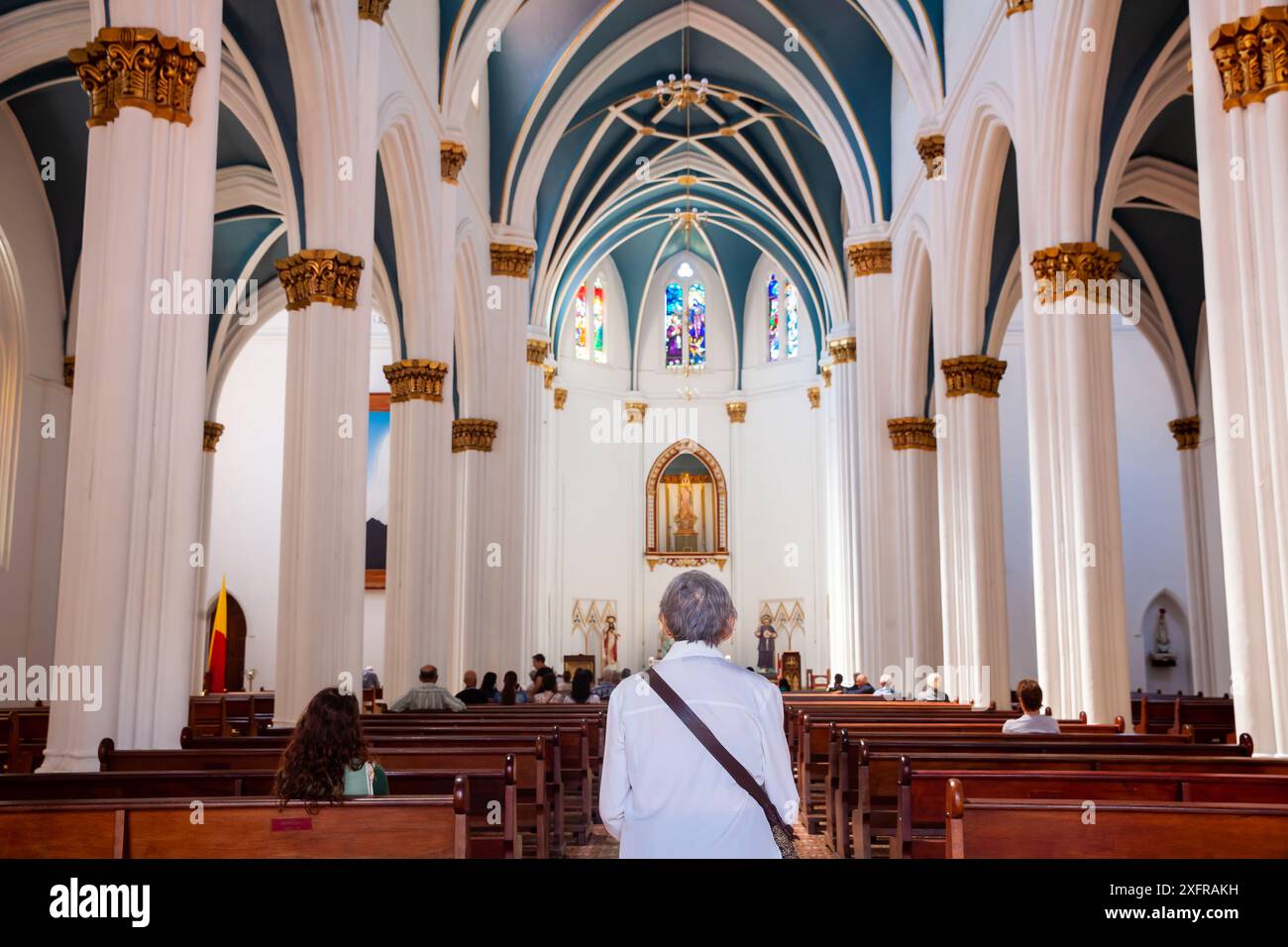 Senior woman praying to the Holy Mother Laura Montoya at the Sacred ...