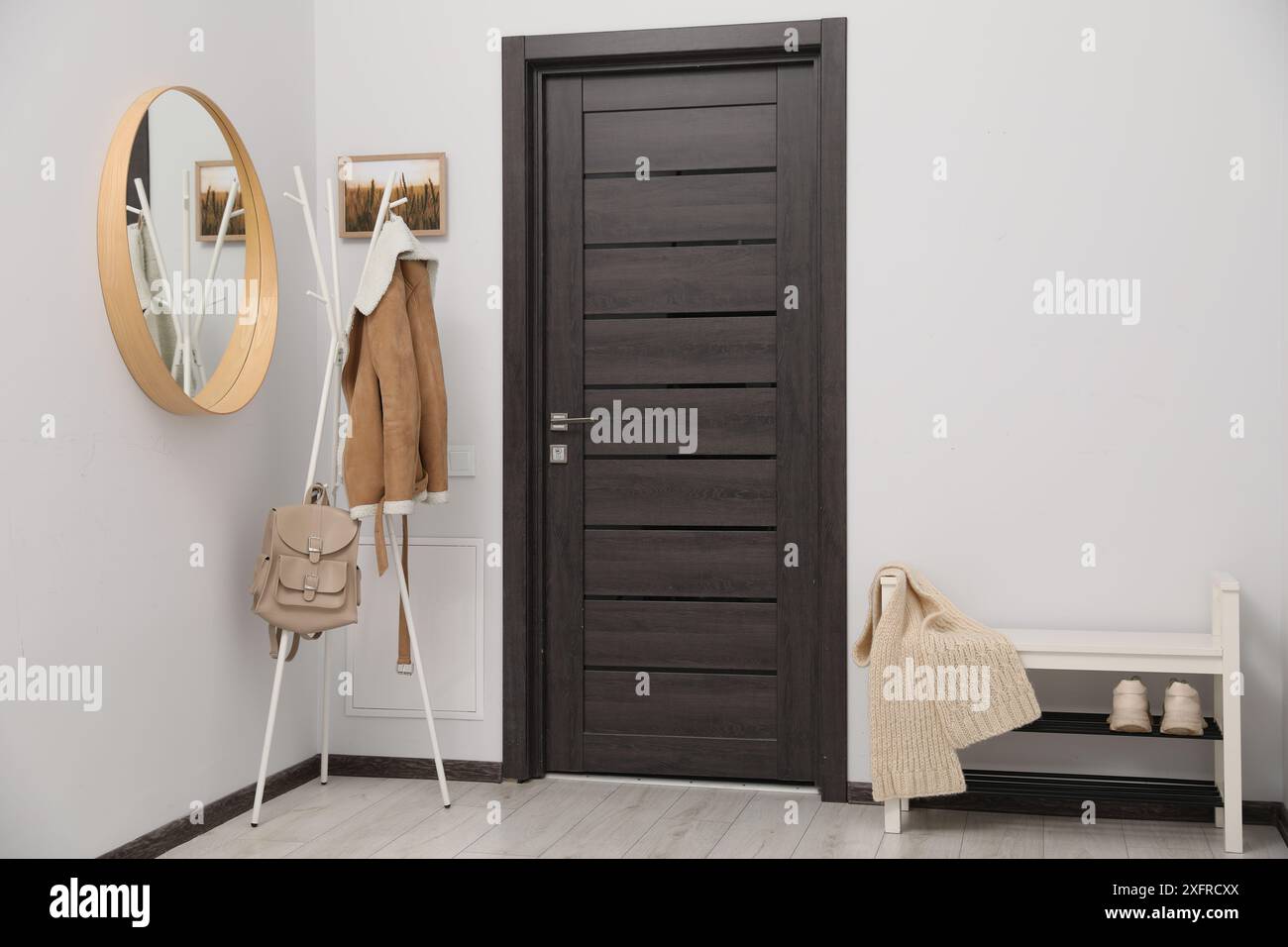 Coat rack, mirror and shoe storage bench in hallway. Interior design ...