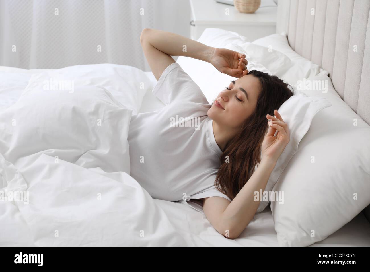 Bedtime. Beautiful woman lying in bed at home Stock Photo - Alamy