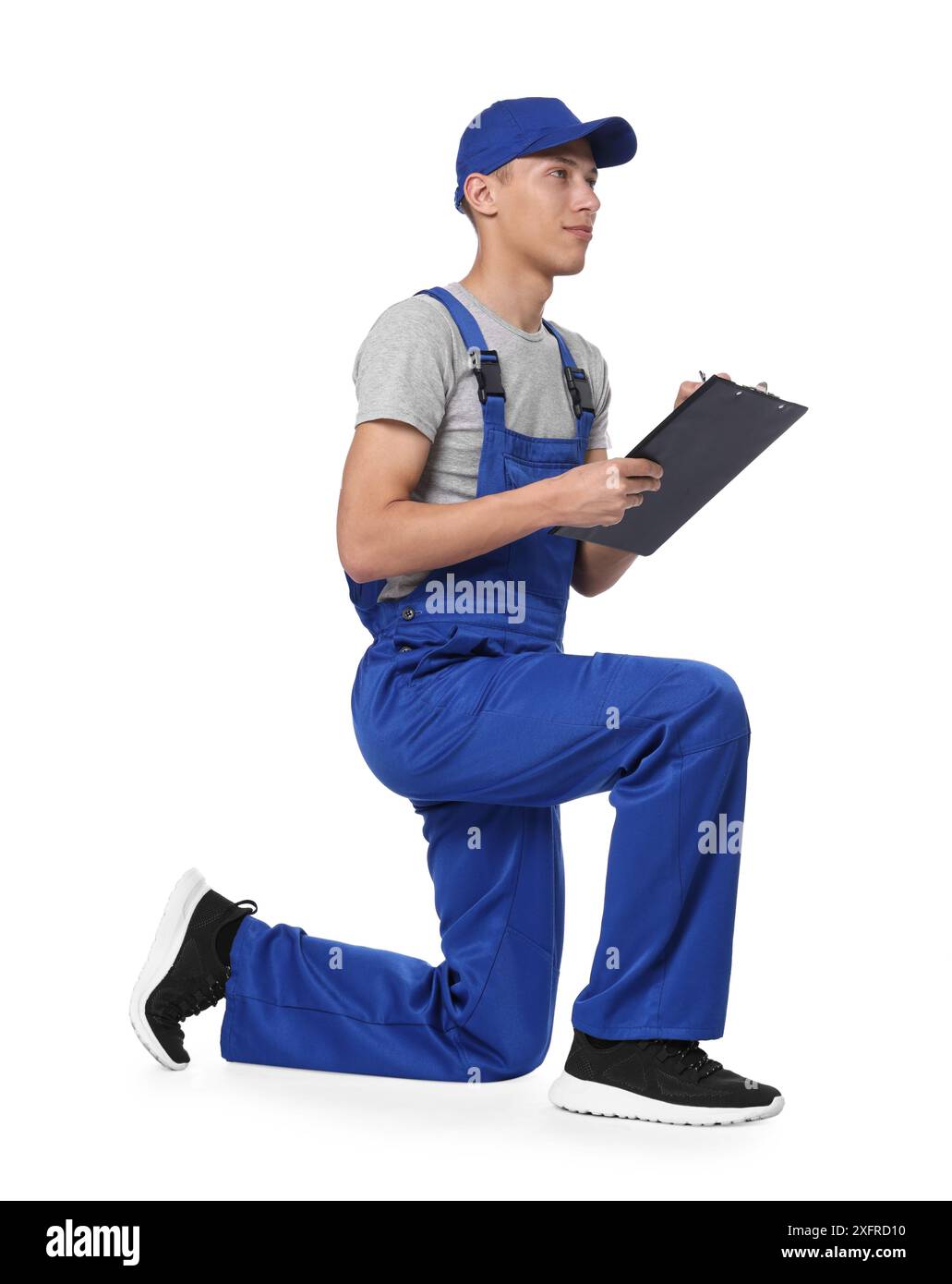 Auto mechanic working with clipboard on white background Stock Photo ...