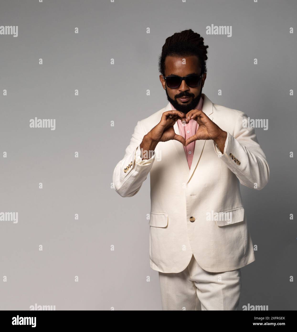 afro cuban with dreadlocks in suit doing a heart with the hands Stock ...