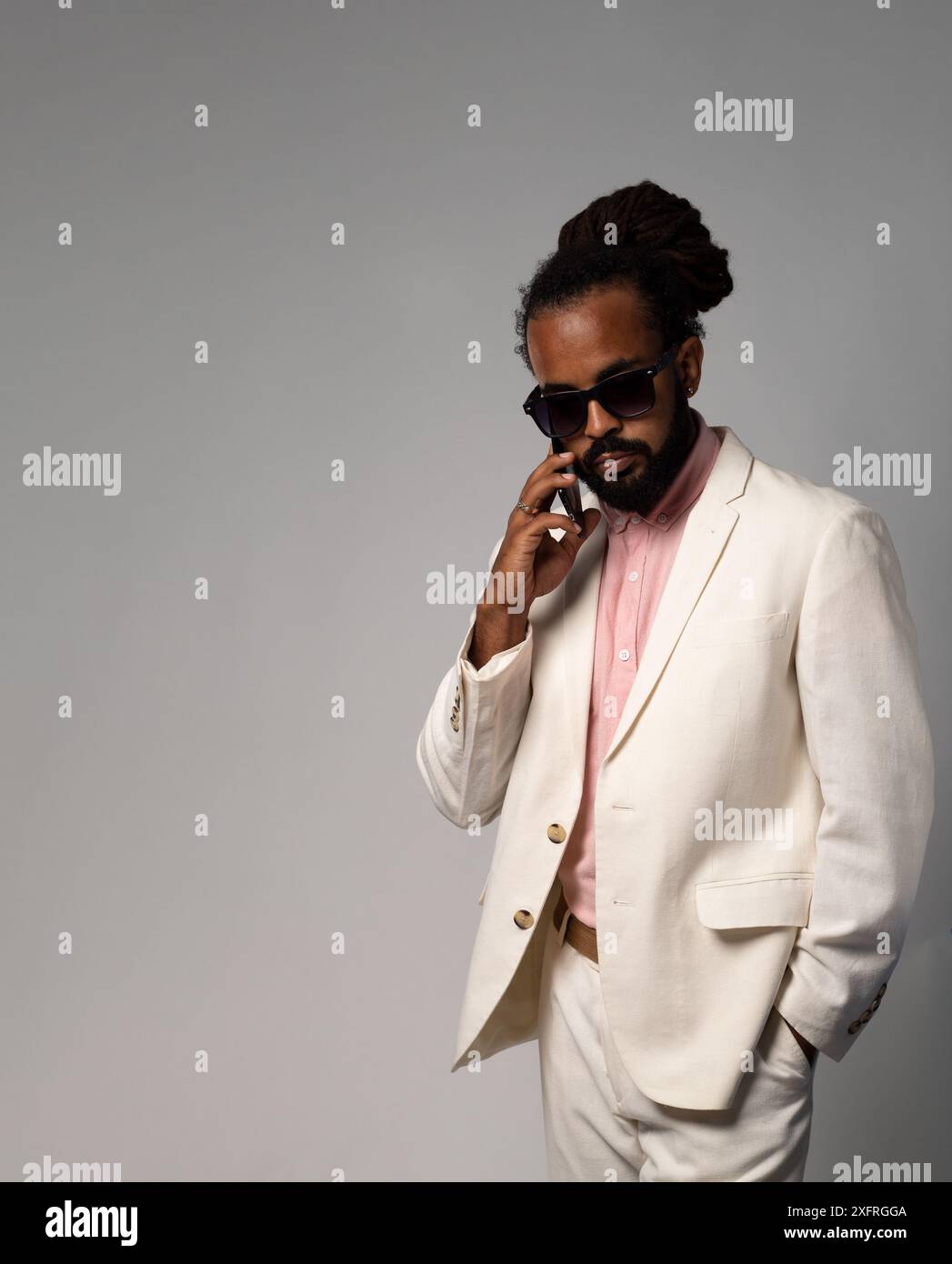 afro cuban with dreadlocks in suit talking by cell isolated Stock Photo ...