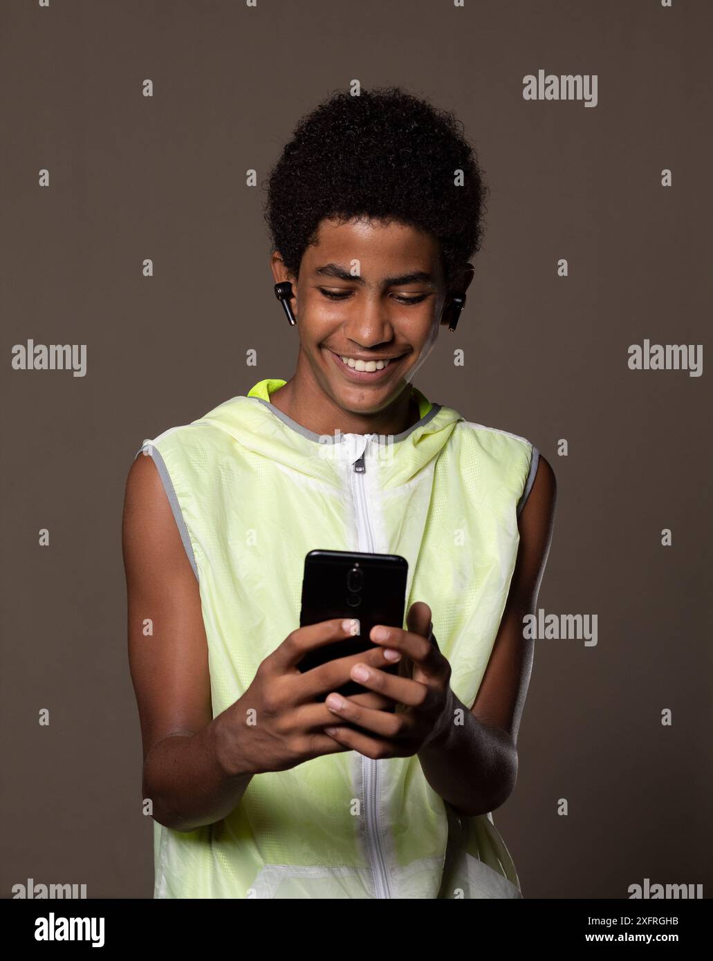 Emotional portrait of teen boy looking the cell smiling Stock Photo - Alamy