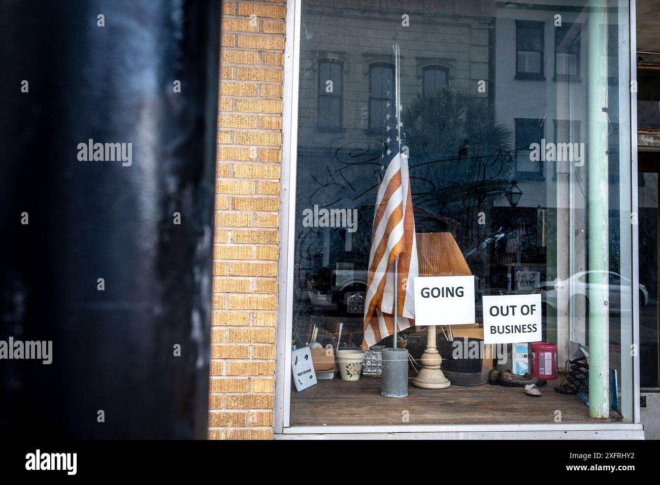 American flag and "Going Out of Business" sign in a shop window Stock ...