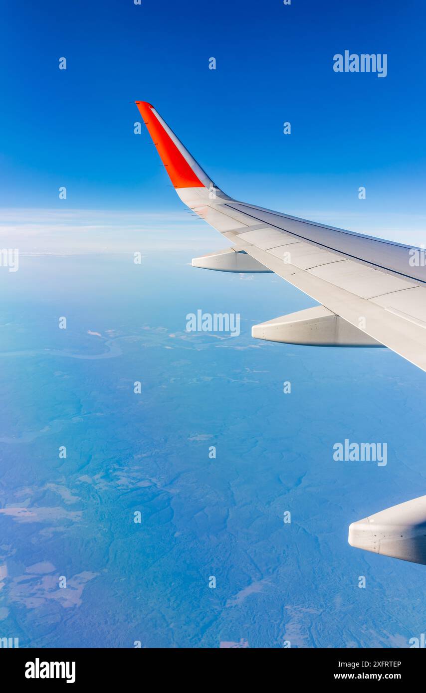 Aerial view from airplane window above green ground. View from the ...