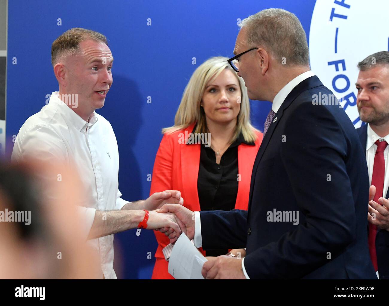 Sinn Fein candidate Chris Hazzard (left) after winning the South Down ...