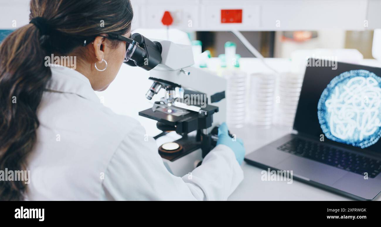 Woman, science and laptop with microscope in lab, microbiology and ...