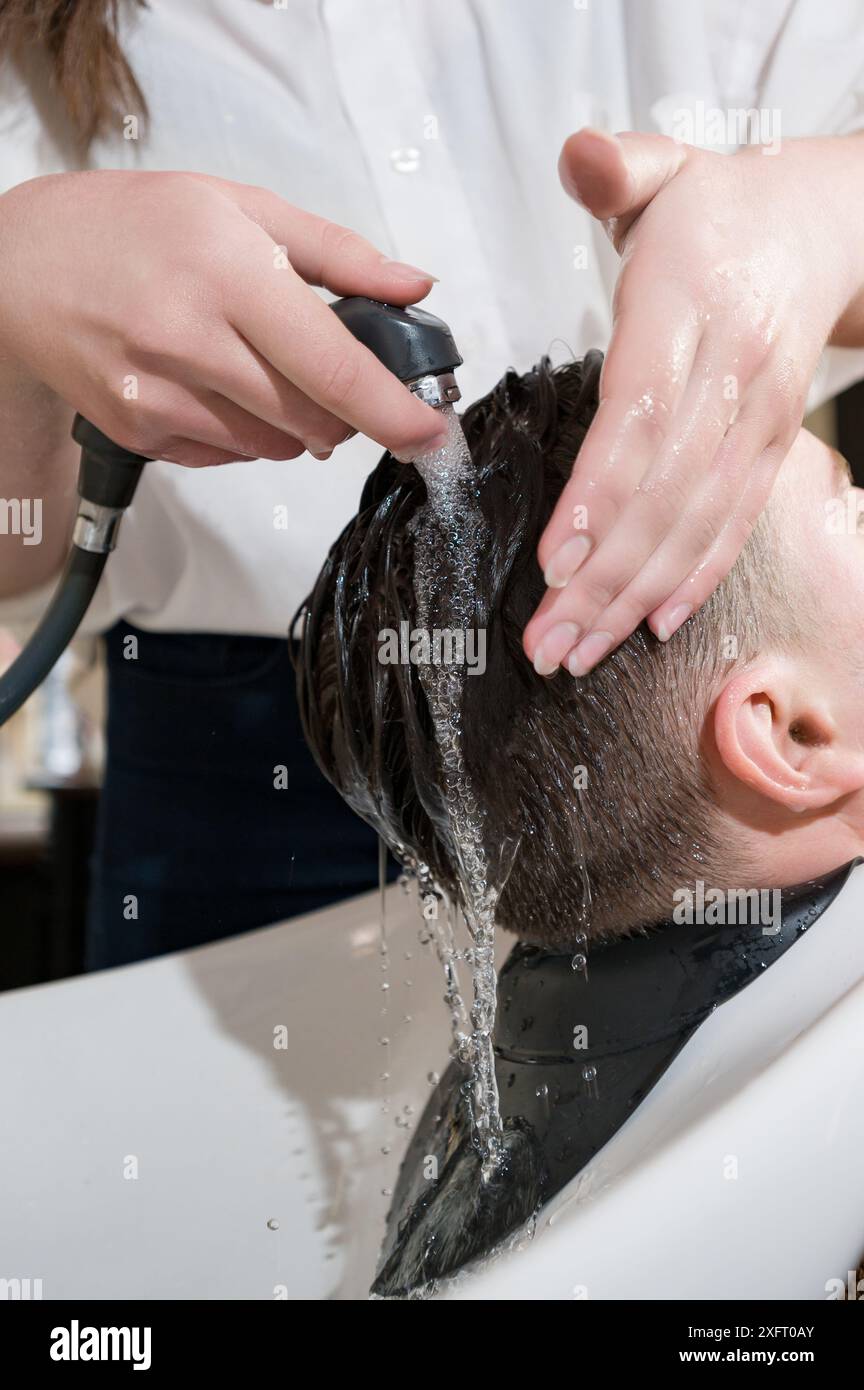 Barber shampooing washing a male clients head in the sink Stock Photo ...