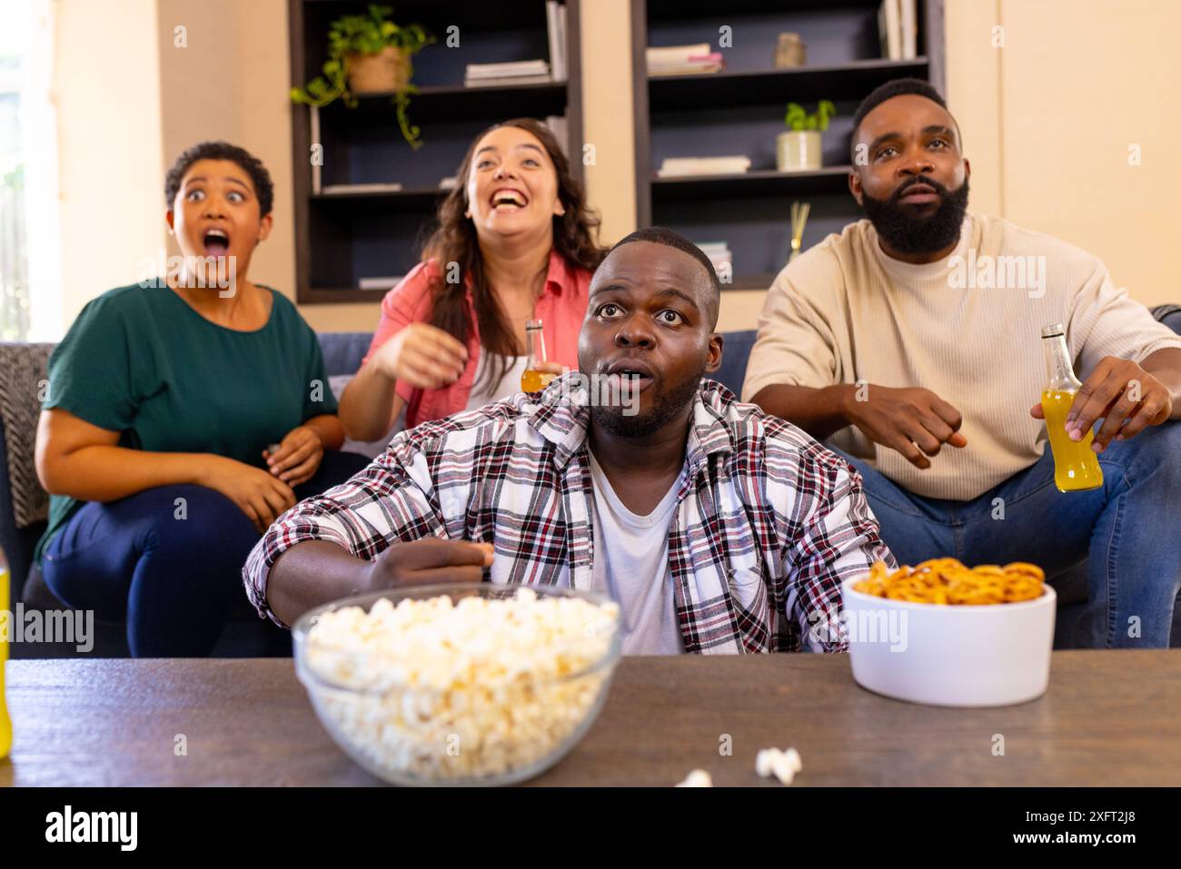 Diverse group friends watching tv hi-res stock photography and images ...