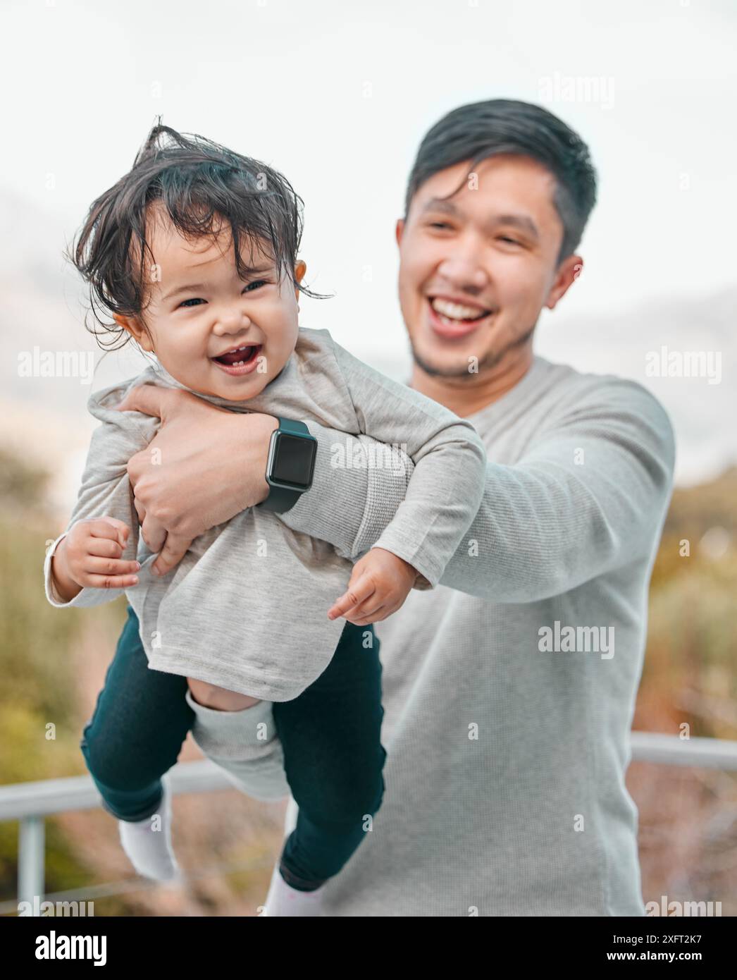 Asian family, father and baby flying game on balcony, laughing and ...