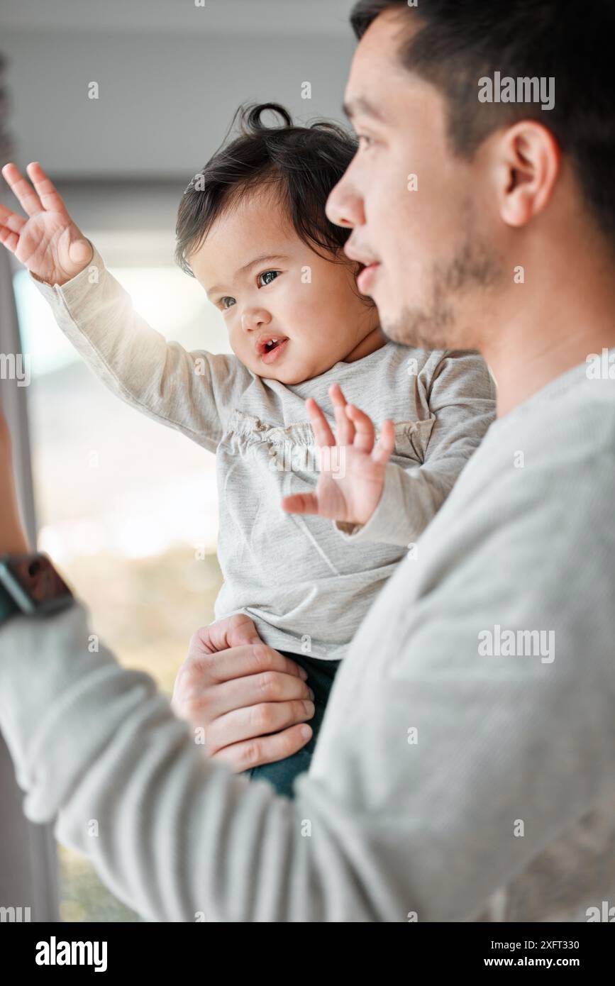 Father, baby and talking in home together, bonding and communication ...