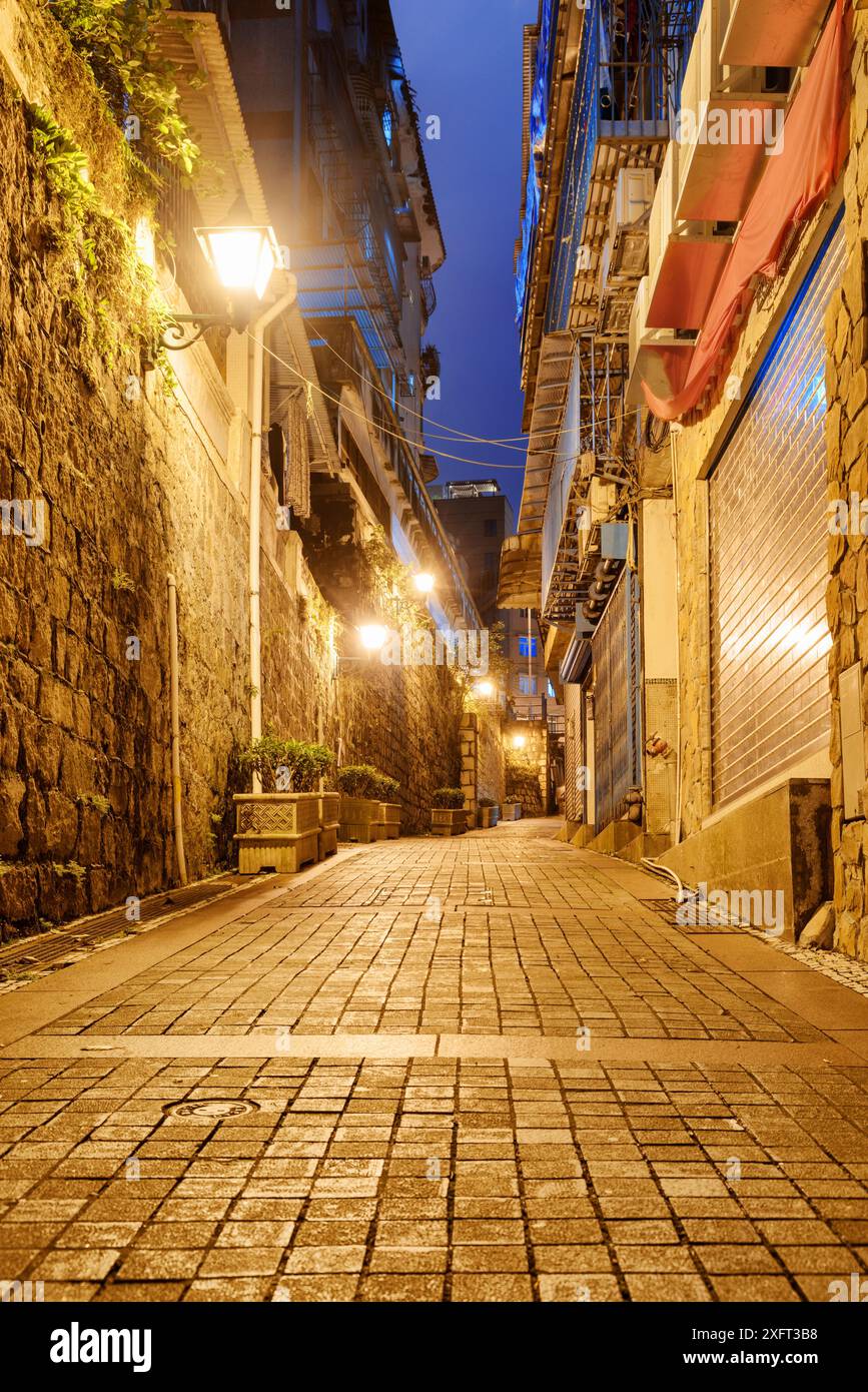 Wonderful night view of narrow street at old town of Macau. Modern high ...
