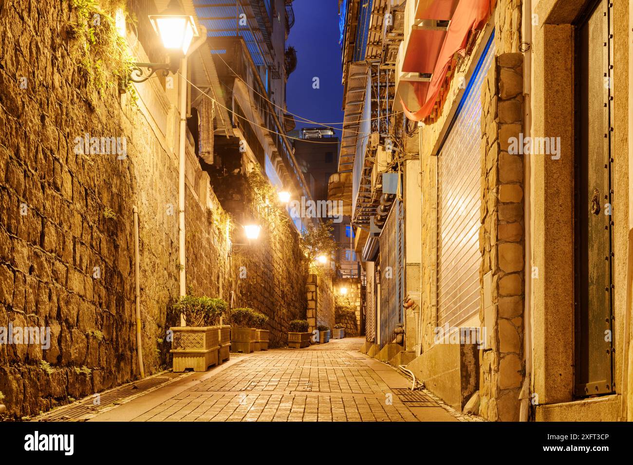 Wonderful night view of narrow street at old town of Macau. Modern high ...