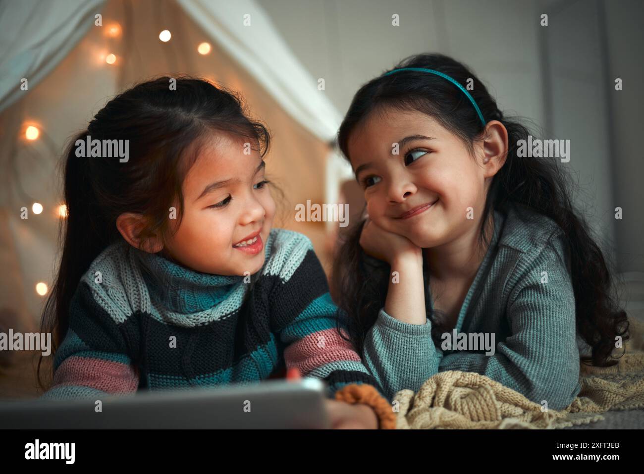 Sisters, internet and kids in bed with tablet for streaming animation ...