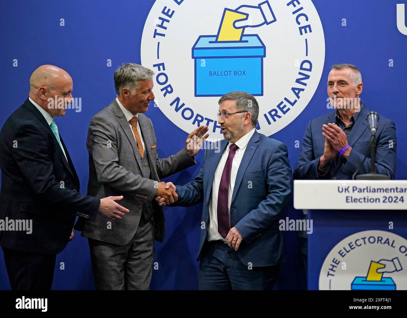 UUP MP Robin Swann shakes hands with outgoing South Antrim MP Paul ...