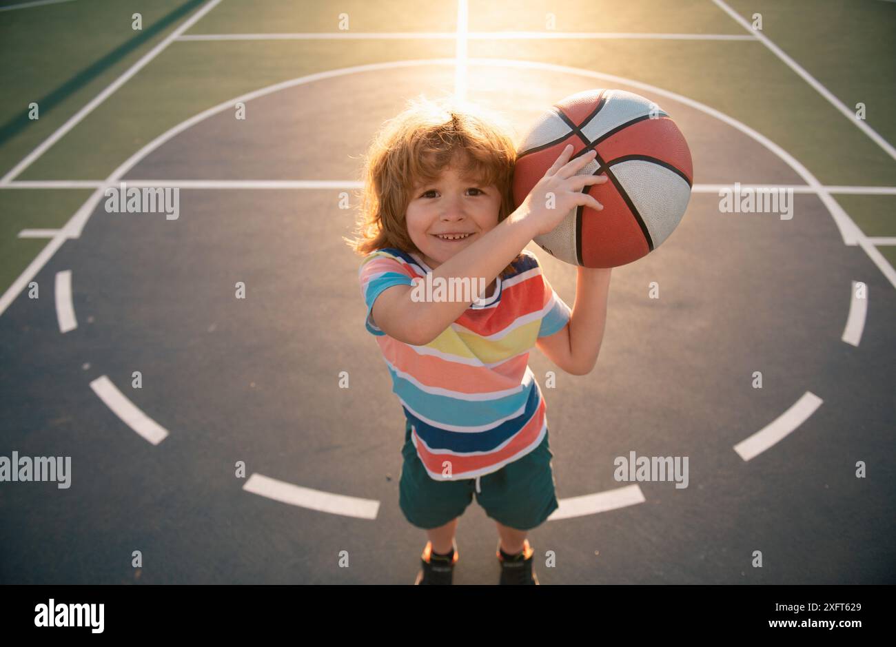 Kid little boy playing basketball with basket ball Stock Photo - Alamy
