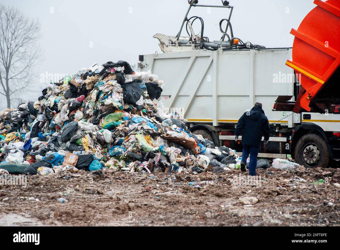 Dump municipal waste. Workers with trucks and bulldozers at work in ...