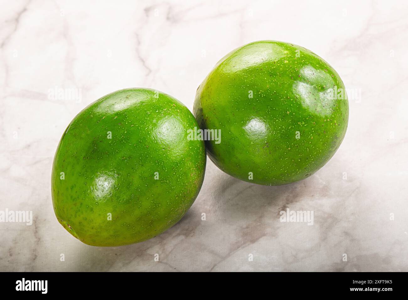 Two ripe green exotic avocado whole fruit Stock Photo - Alamy