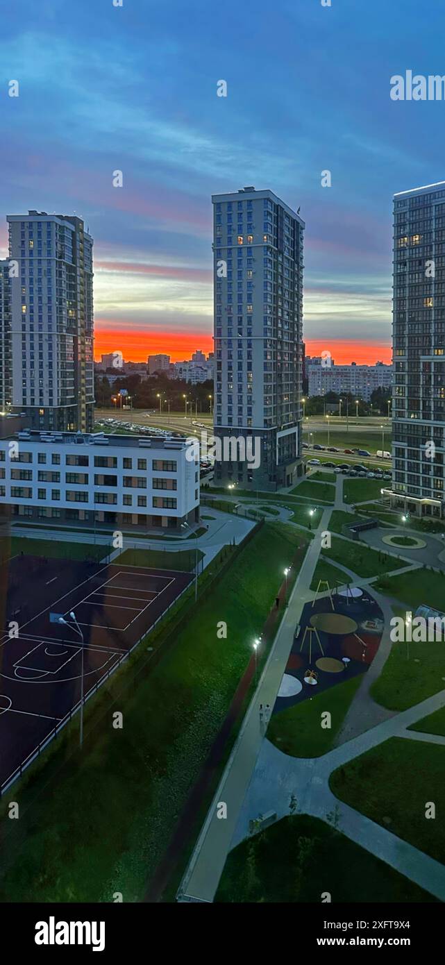Multistory buildings megapolis at sunset. Modern buildings, playgrounds ...