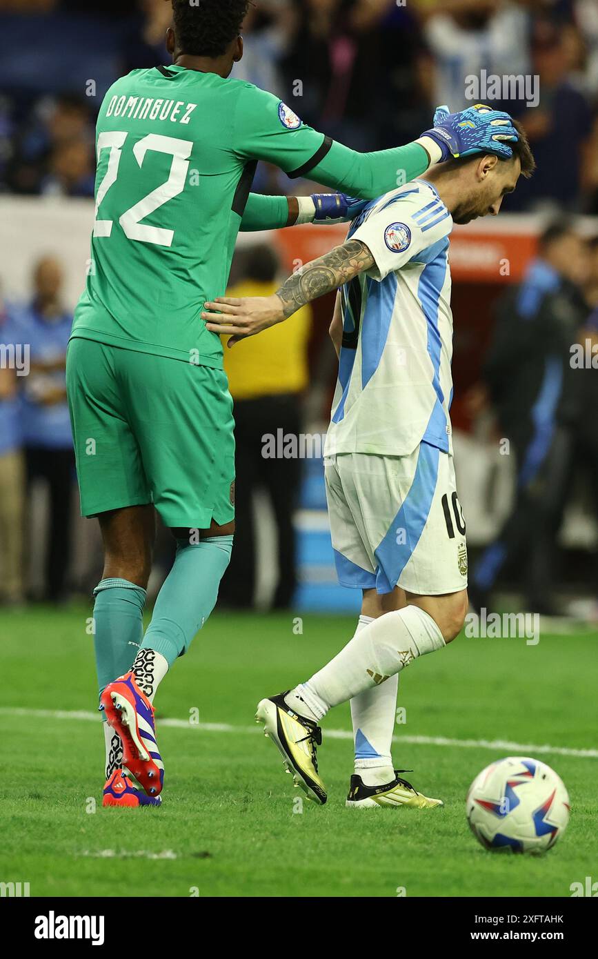 Argentine striker Lionel Messi (R) is comforted by Ecuador's goalkeeper ...