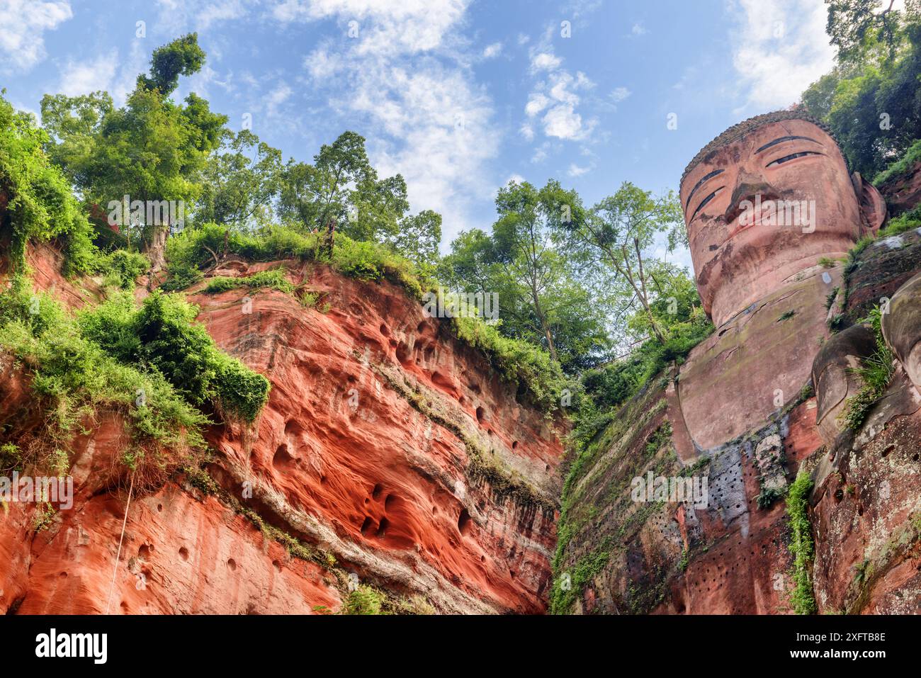 The Leshan Giant Buddha on blue sky background. Bottom view on sunny ...