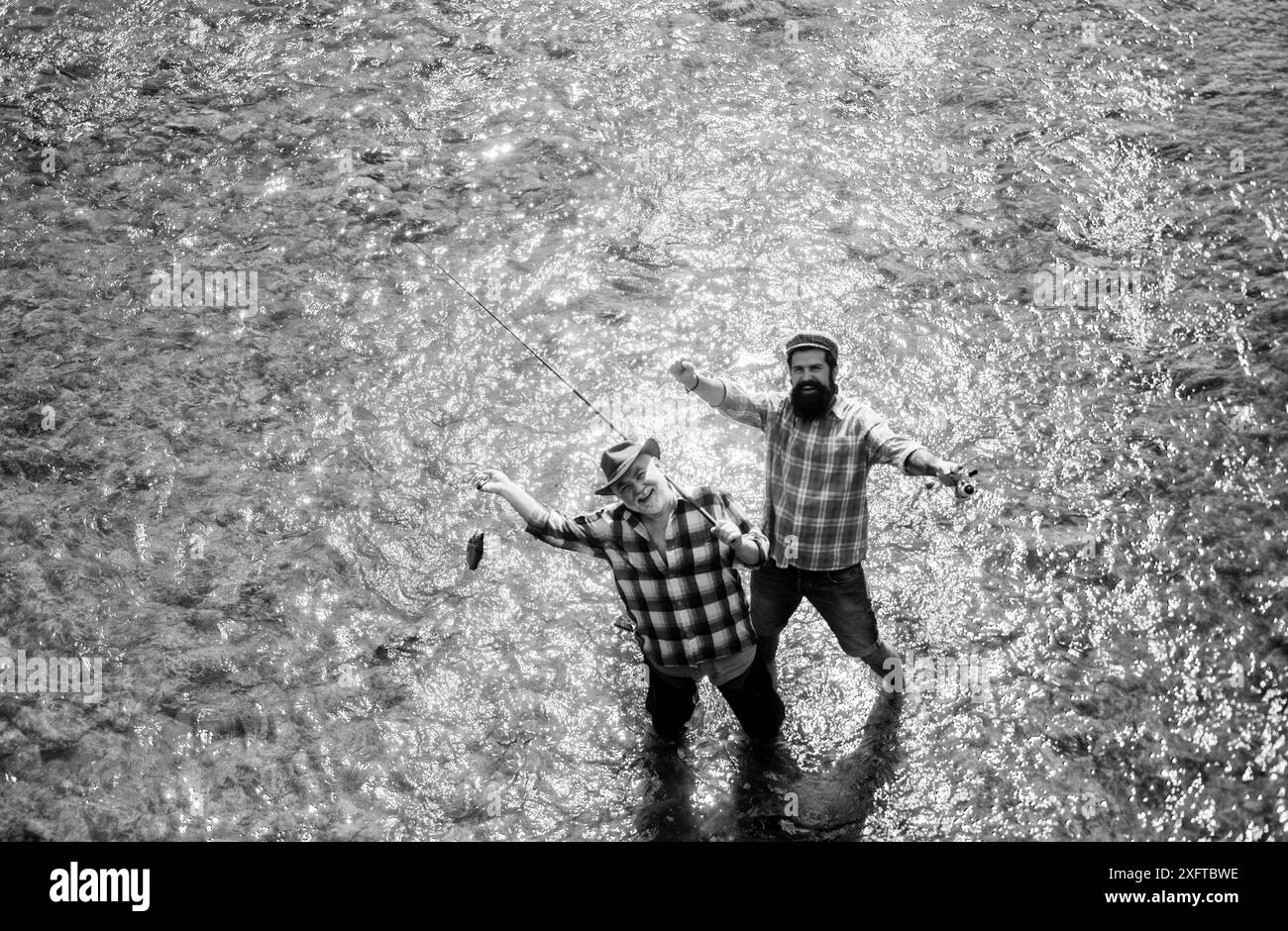 Two men friends fishing. Flyfishing angler makes cast, standing in ...