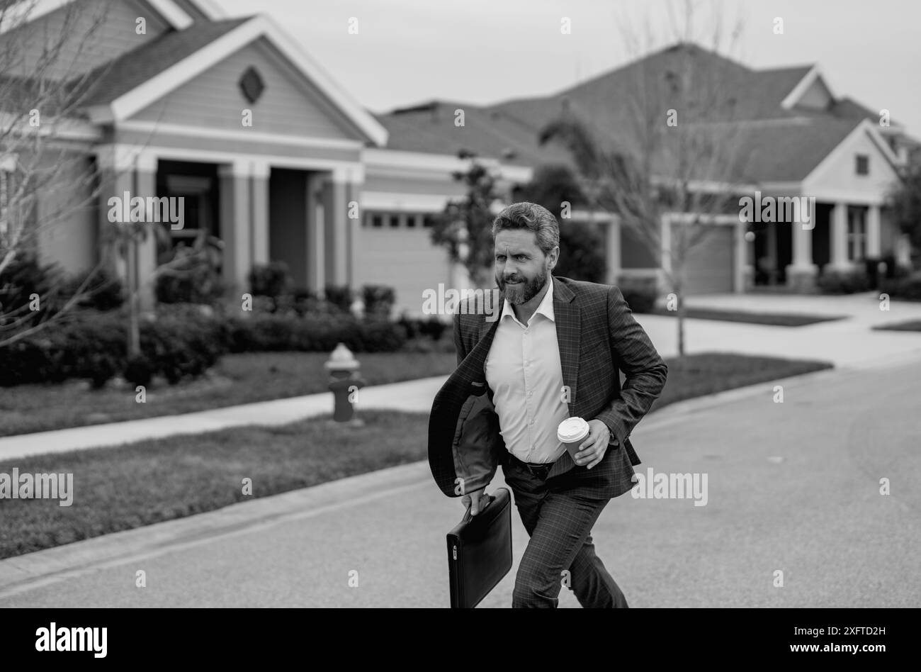 Man walking down street house Black and White Stock Photos & Images - Alamy