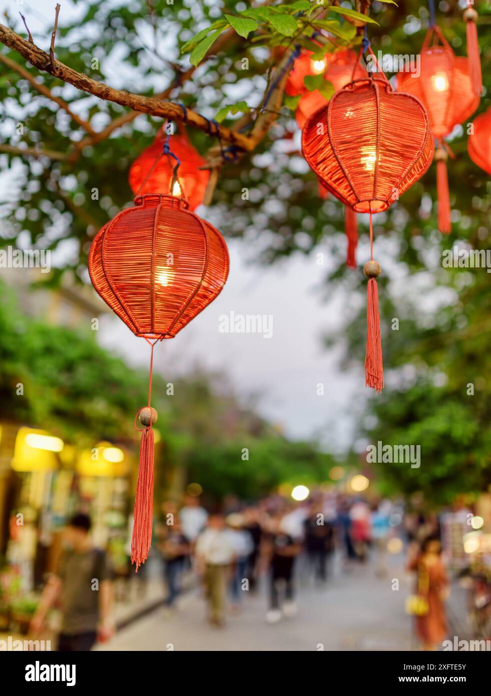 Amazing evening view of green tree decorated with traditional red ...