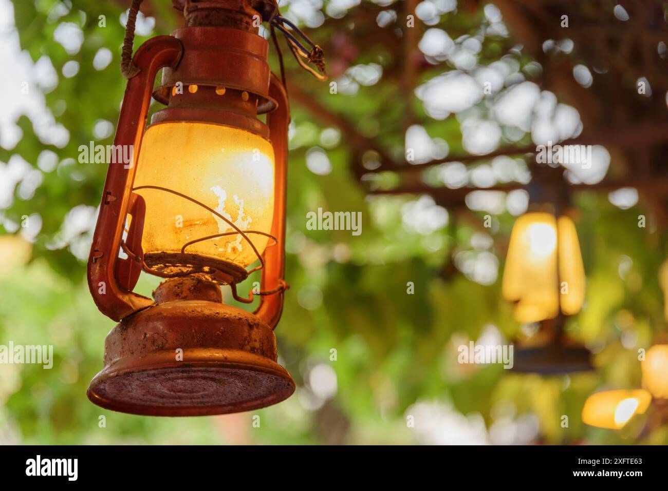 Old street lights on green foliage background. Vintage style lighting ...