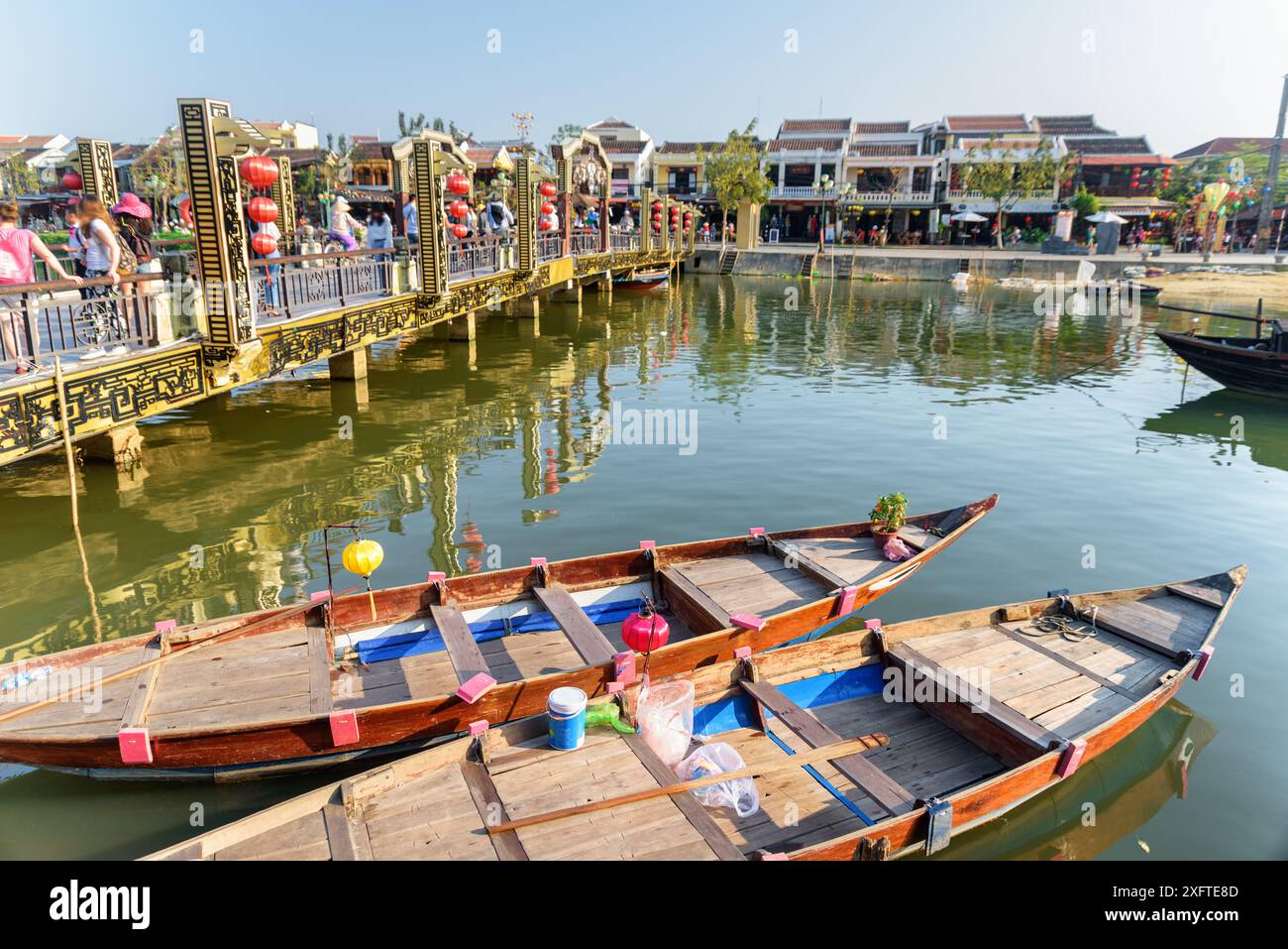 Tourist wooden boats and scenic bridge over the Thu Bon River in Hoi An ...